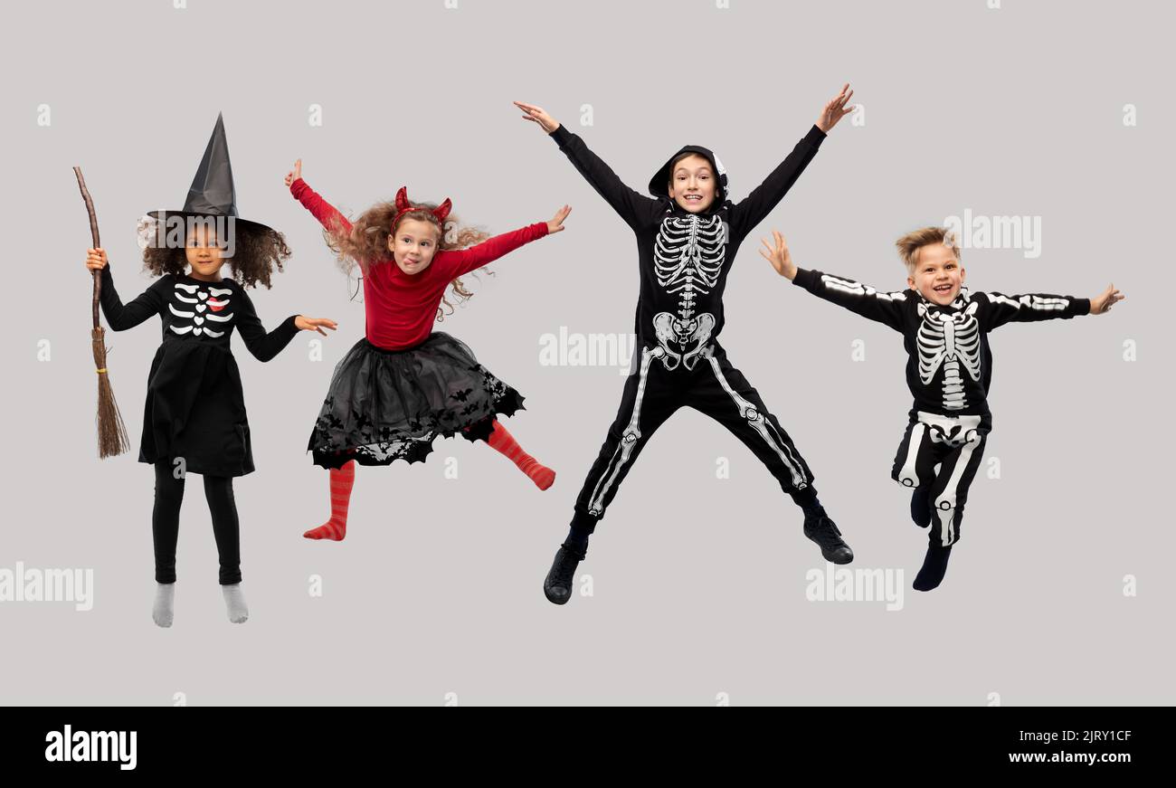 happy children in halloween costumes jumping Stock Photo - Alamy
