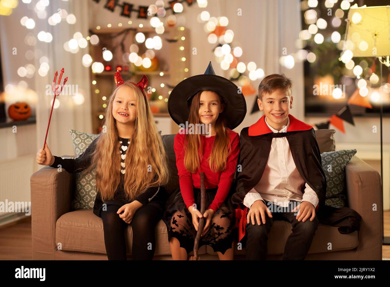 kids in halloween costumes at home at night Stock Photo - Alamy