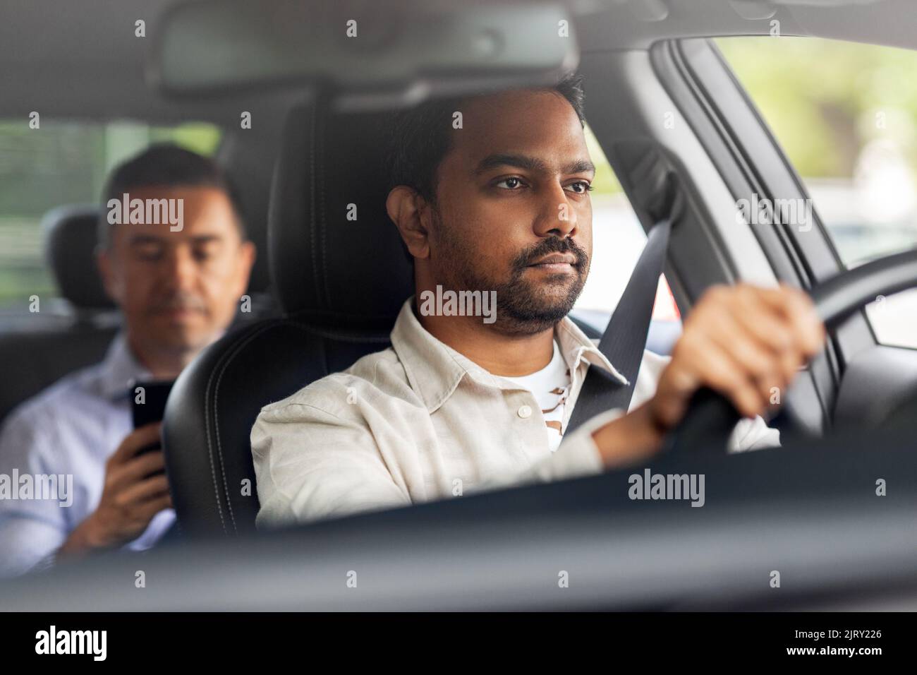 indian male driver driving car with passenger Stock Photo - Alamy