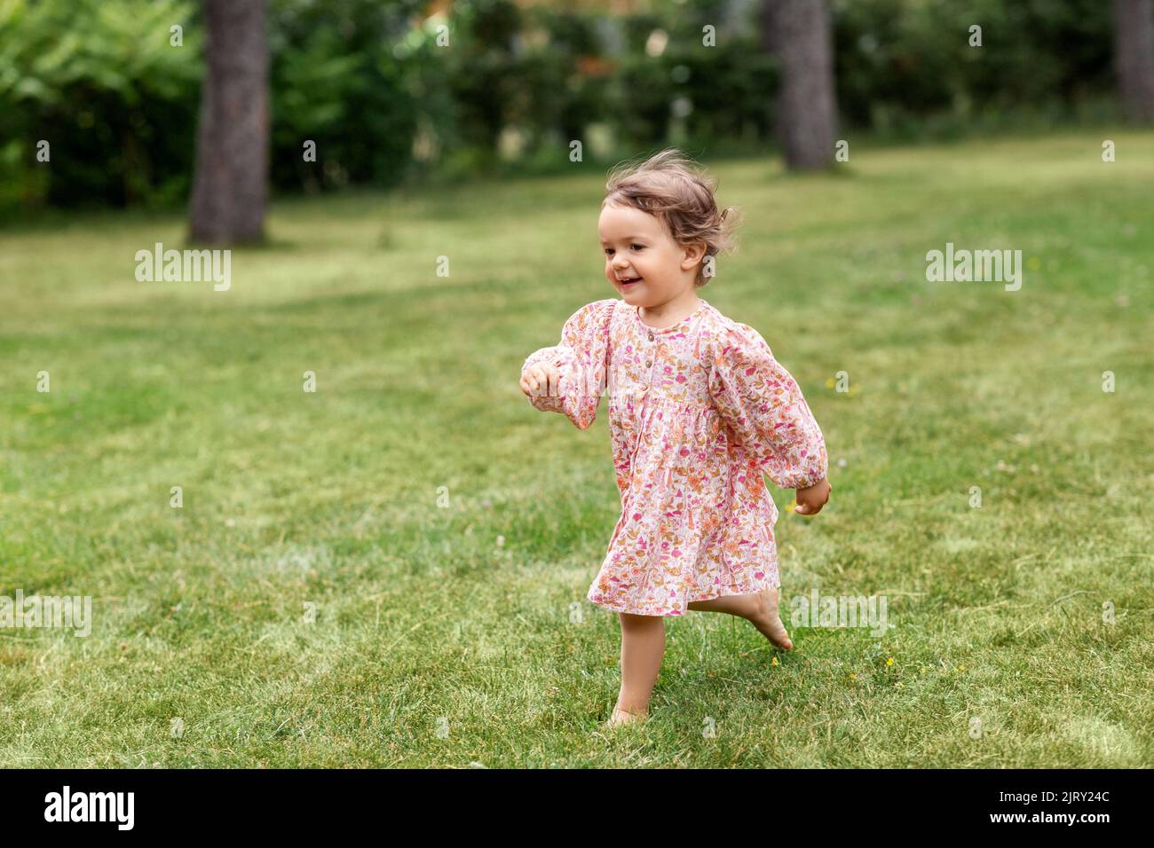 happy little baby girl running across summer field Stock Photo - Alamy