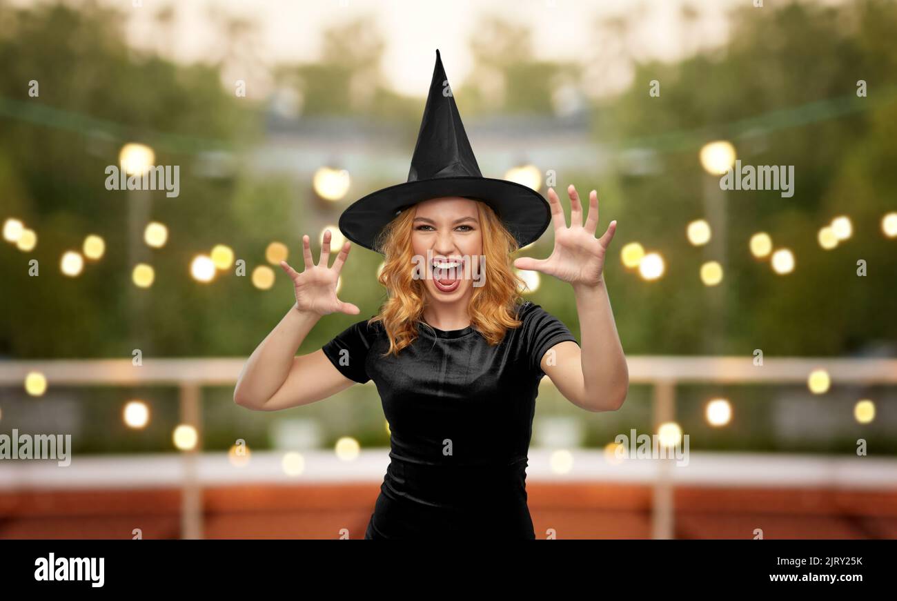 scary woman in black halloween costume of witch Stock Photo - Alamy