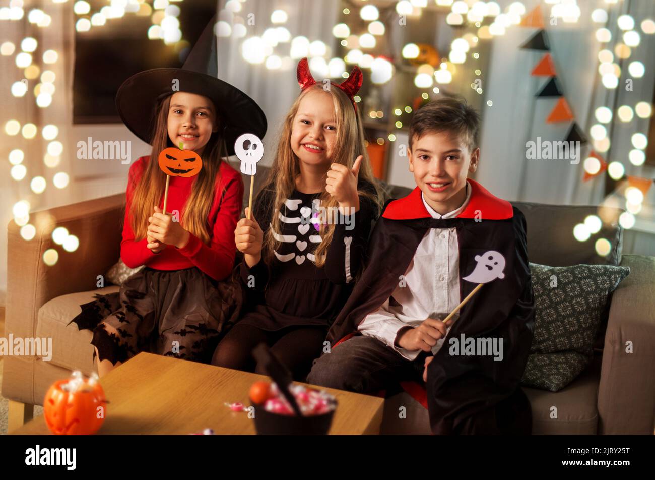 kids in halloween costumes having fun at home Stock Photo - Alamy
