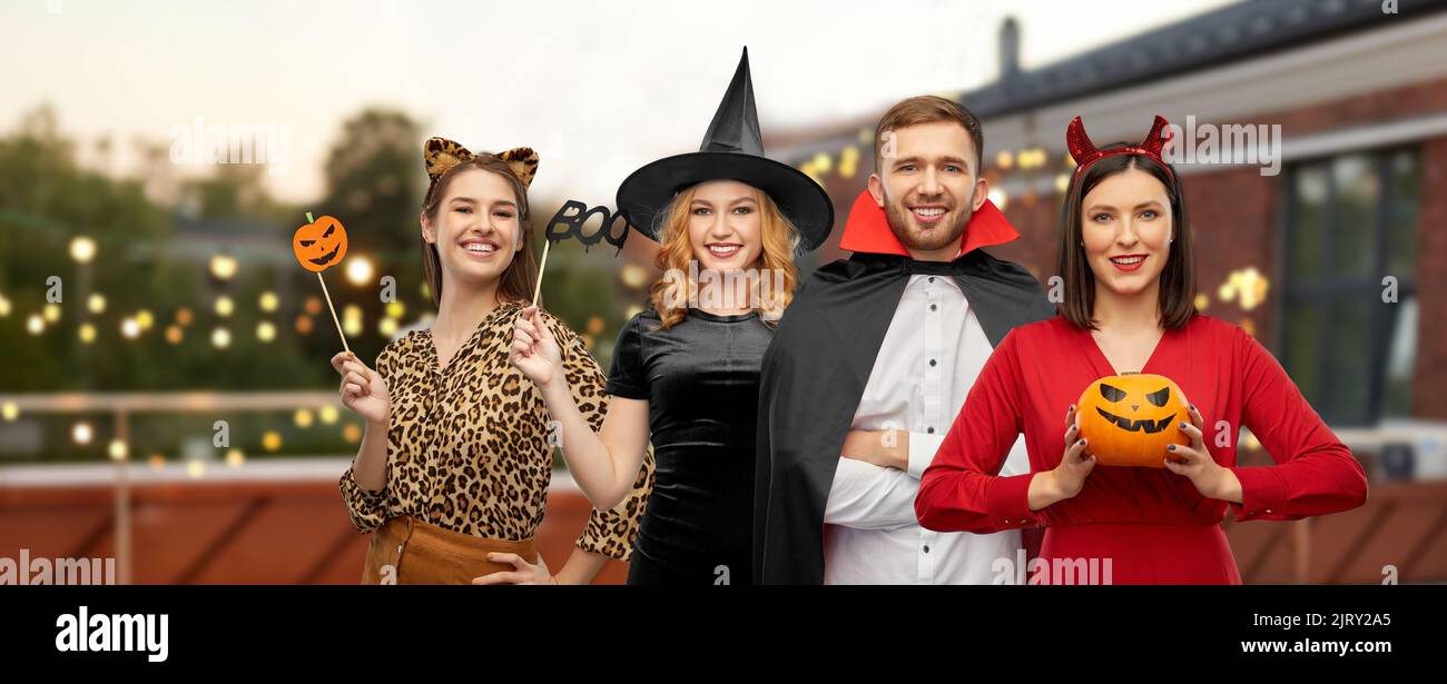 friends in halloween costumes at roof top party Stock Photo - Alamy
