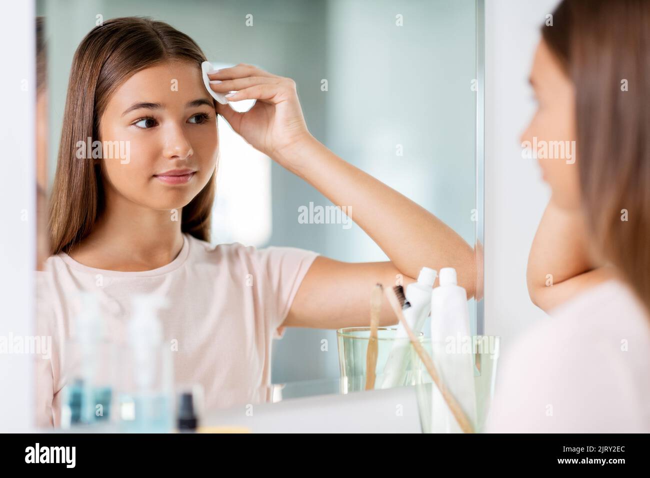 teenage girl cleaning face skin with cotton disc Stock Photo - Alamy