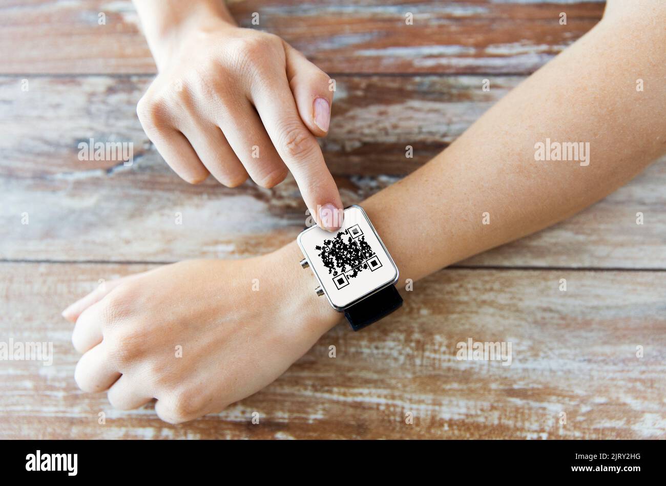 woman's hands with qr code on smart watch Stock Photo - Alamy