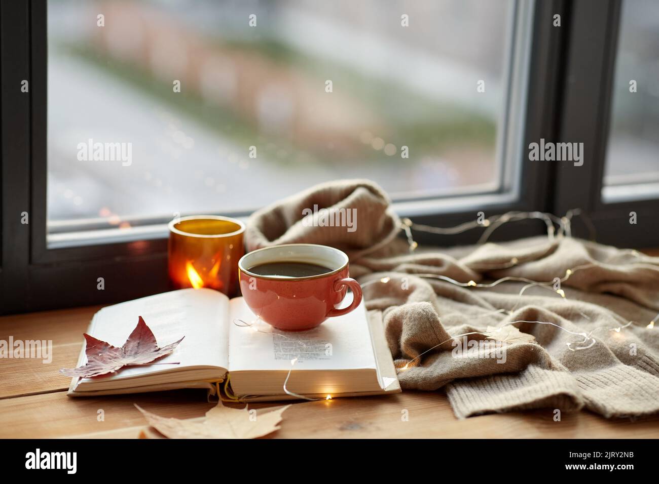 cup of coffee, book on window sill in autumn Stock Photo - Alamy