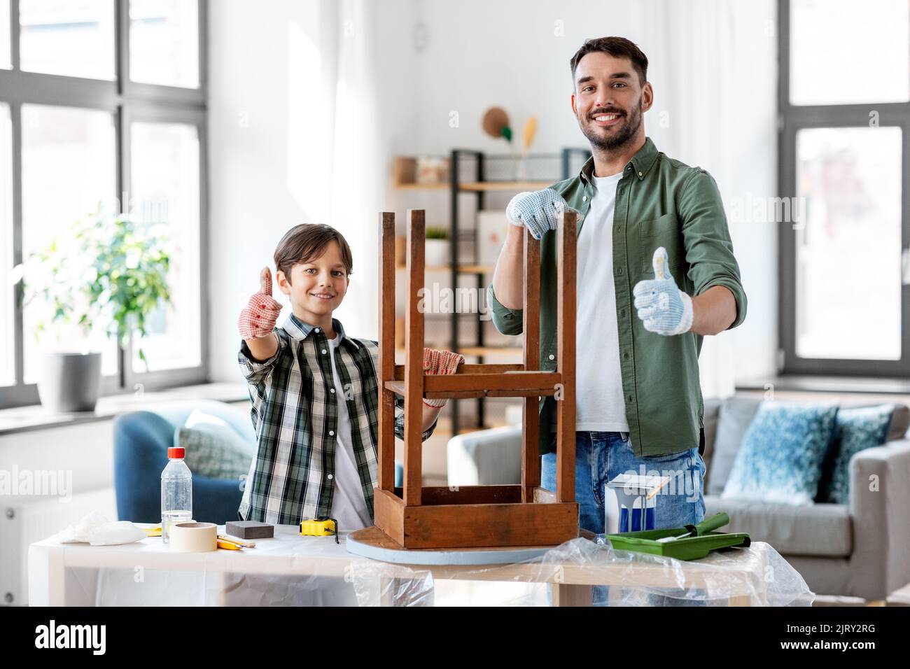 father and son sanding old table with sponge Stock Photo - Alamy