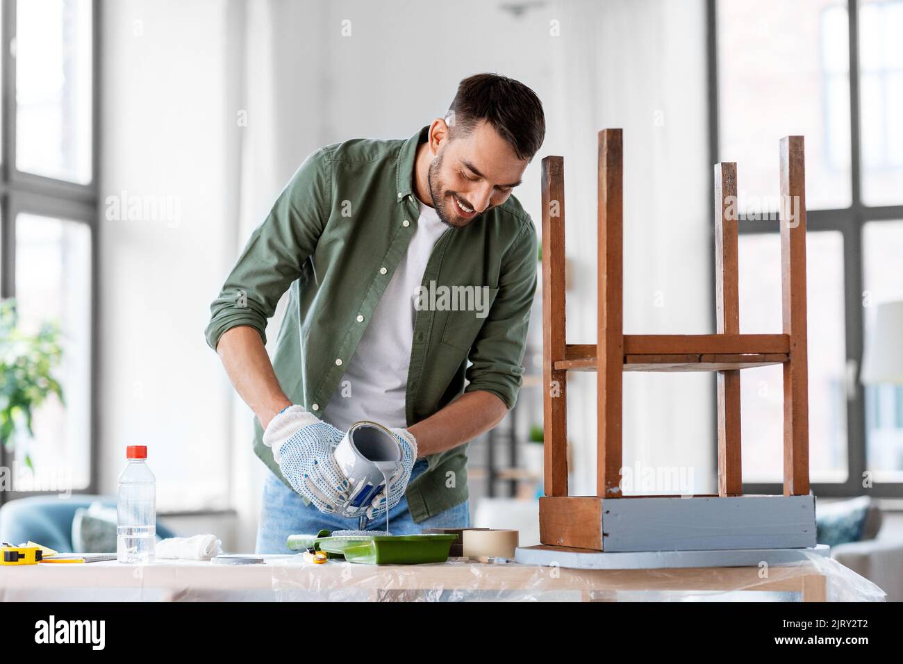 man opening can with grey color at home Stock Photo - Alamy