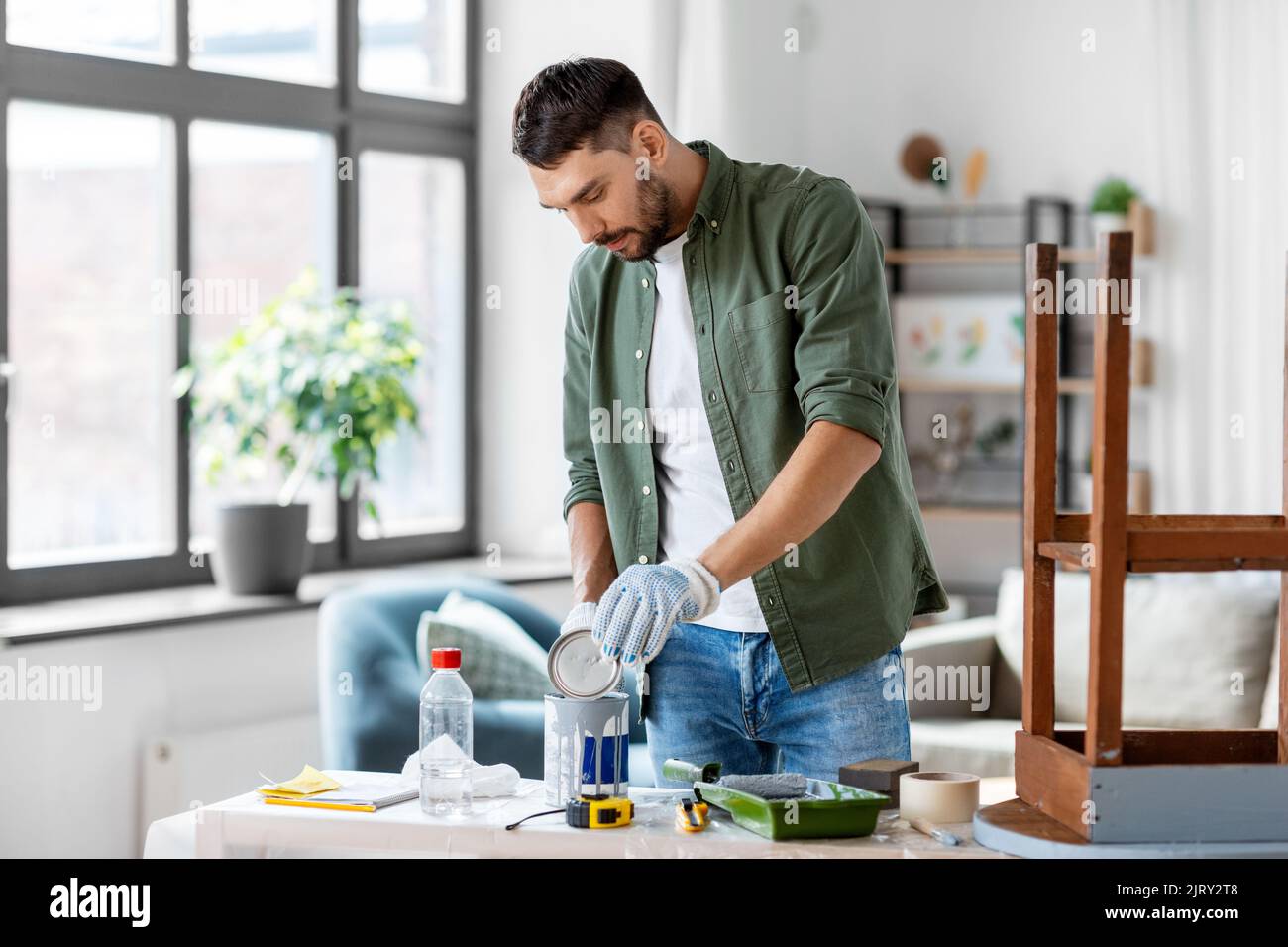 man opening can with grey color at home Stock Photo - Alamy