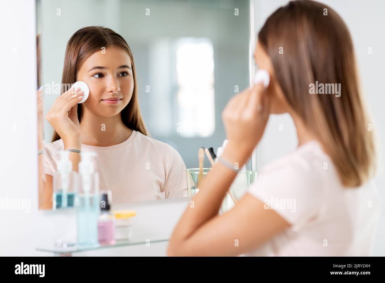 teenage girl cleaning face skin with cotton disc Stock Photo - Alamy