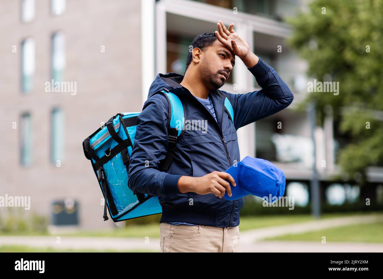 tired indian delivery man with bag in city Stock Photo - Alamy