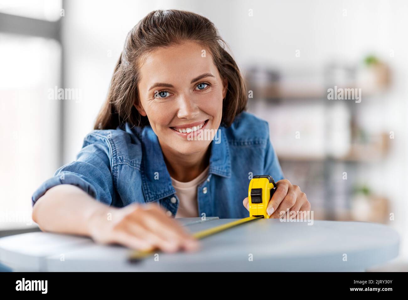 woman with ruler measuring table for renovation Stock Photo - Alamy