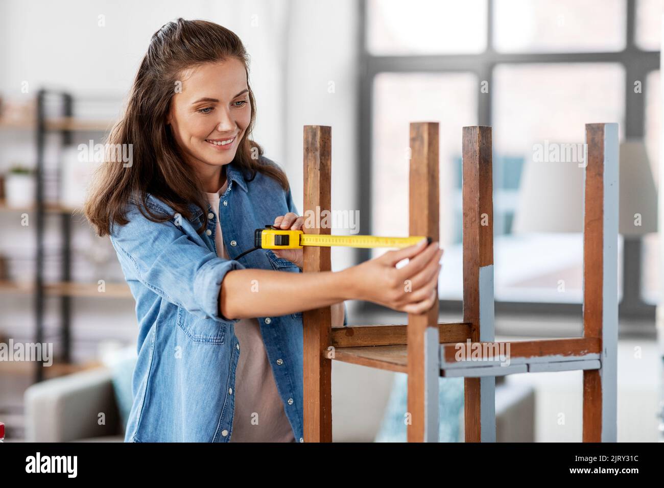 woman with ruler measuring table for renovation Stock Photo - Alamy