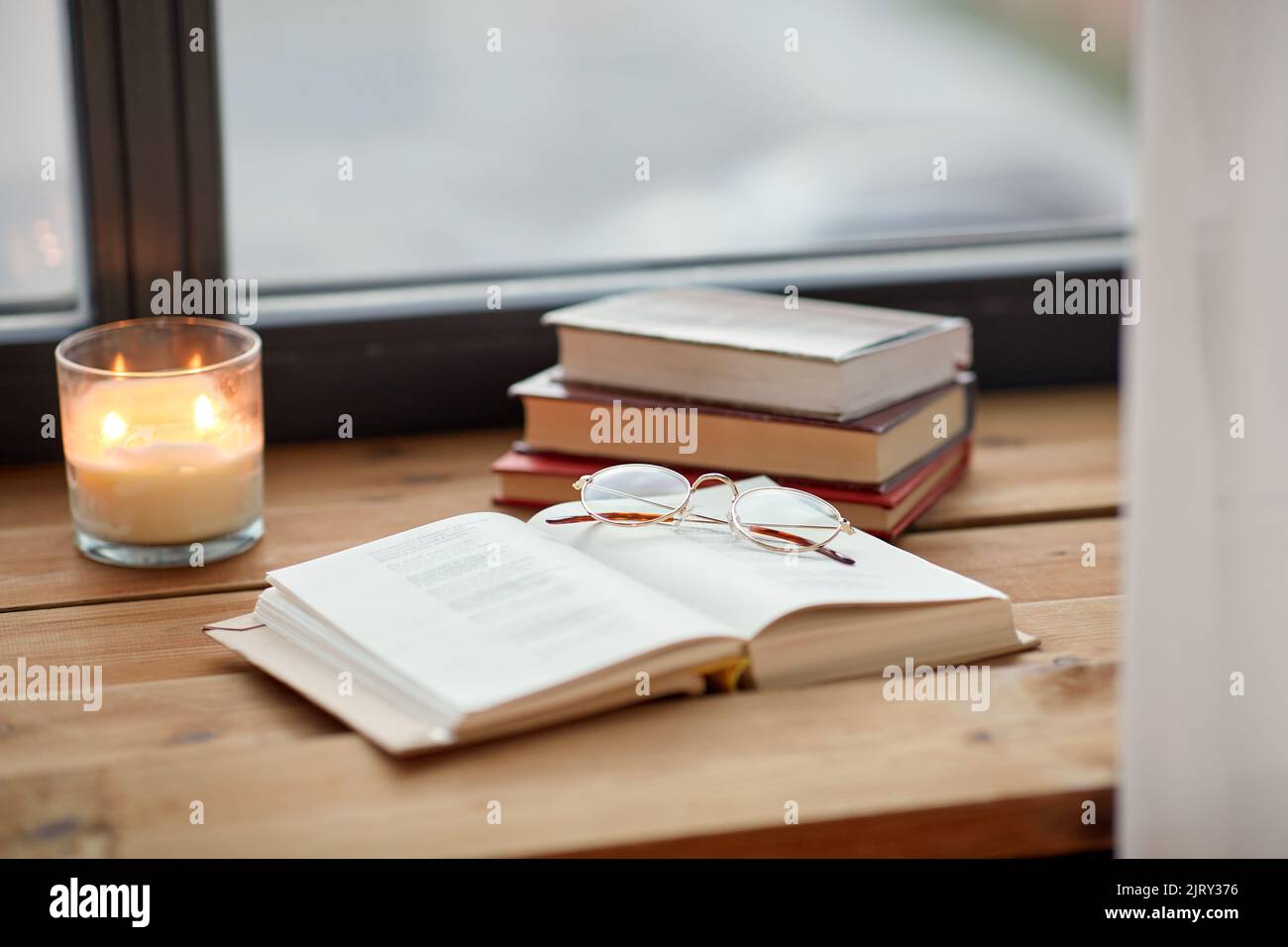 Candle book on sill window hi-res stock photography and images - Alamy