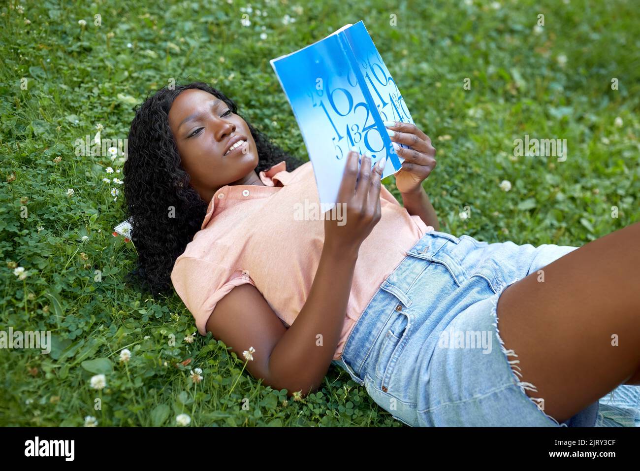 african student girl reading math textbook Stock Photo - Alamy