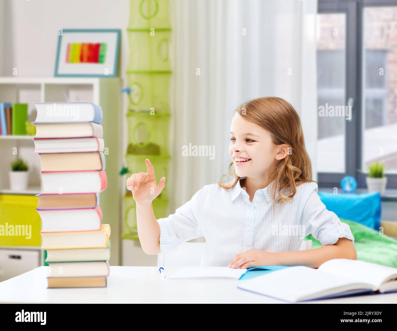 happy smiling student girl reading book at home Stock Photo - Alamy