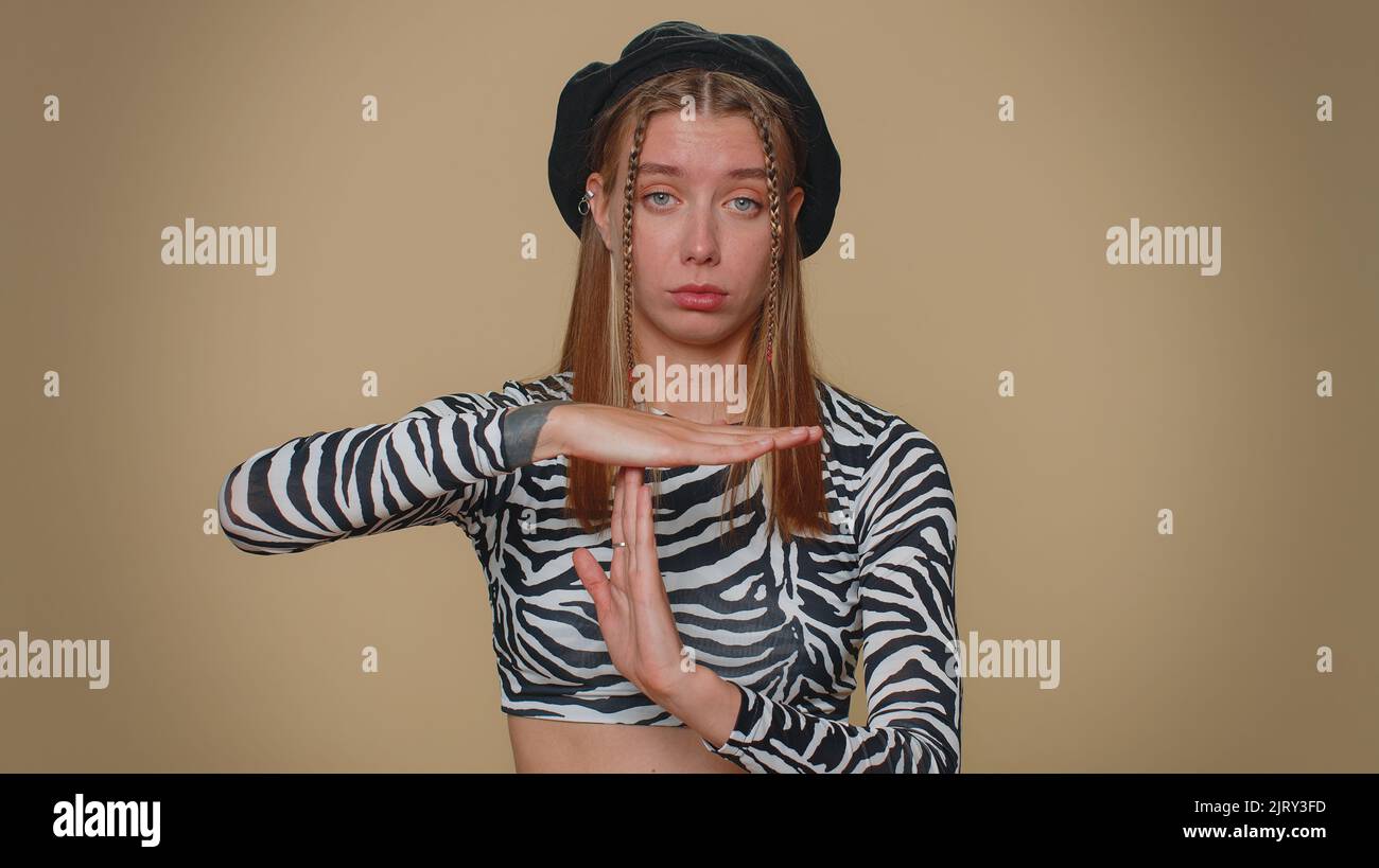 Time out, need a break. Tired serious upset pretty young woman in crop ...