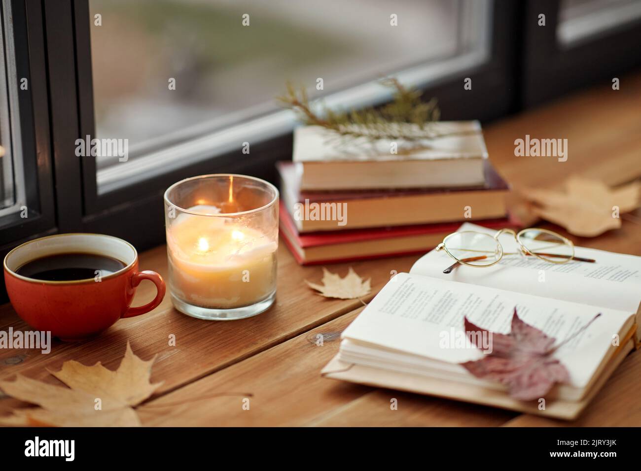 book, coffee and candle on window sill in autumn Stock Photo - Alamy