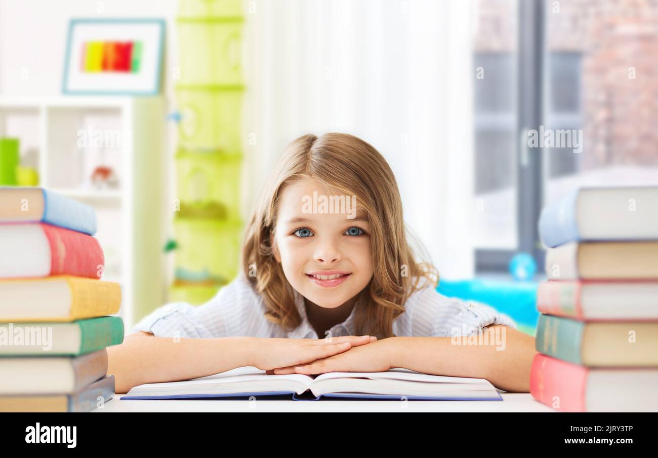 smiling student girl with books learning at home Stock Photo - Alamy