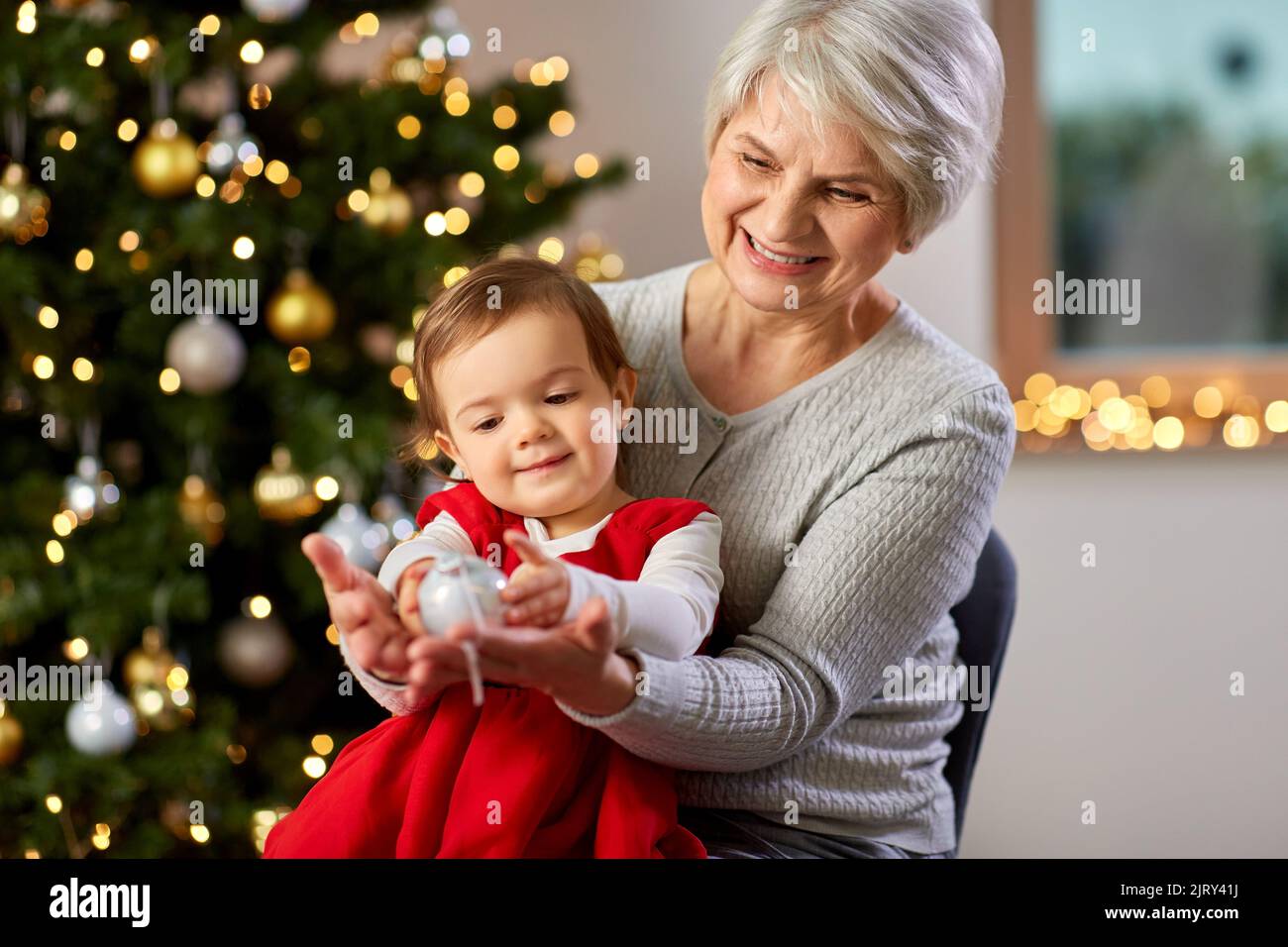 grandmother and baby girl with at christmas tree Stock Photo - Alamy