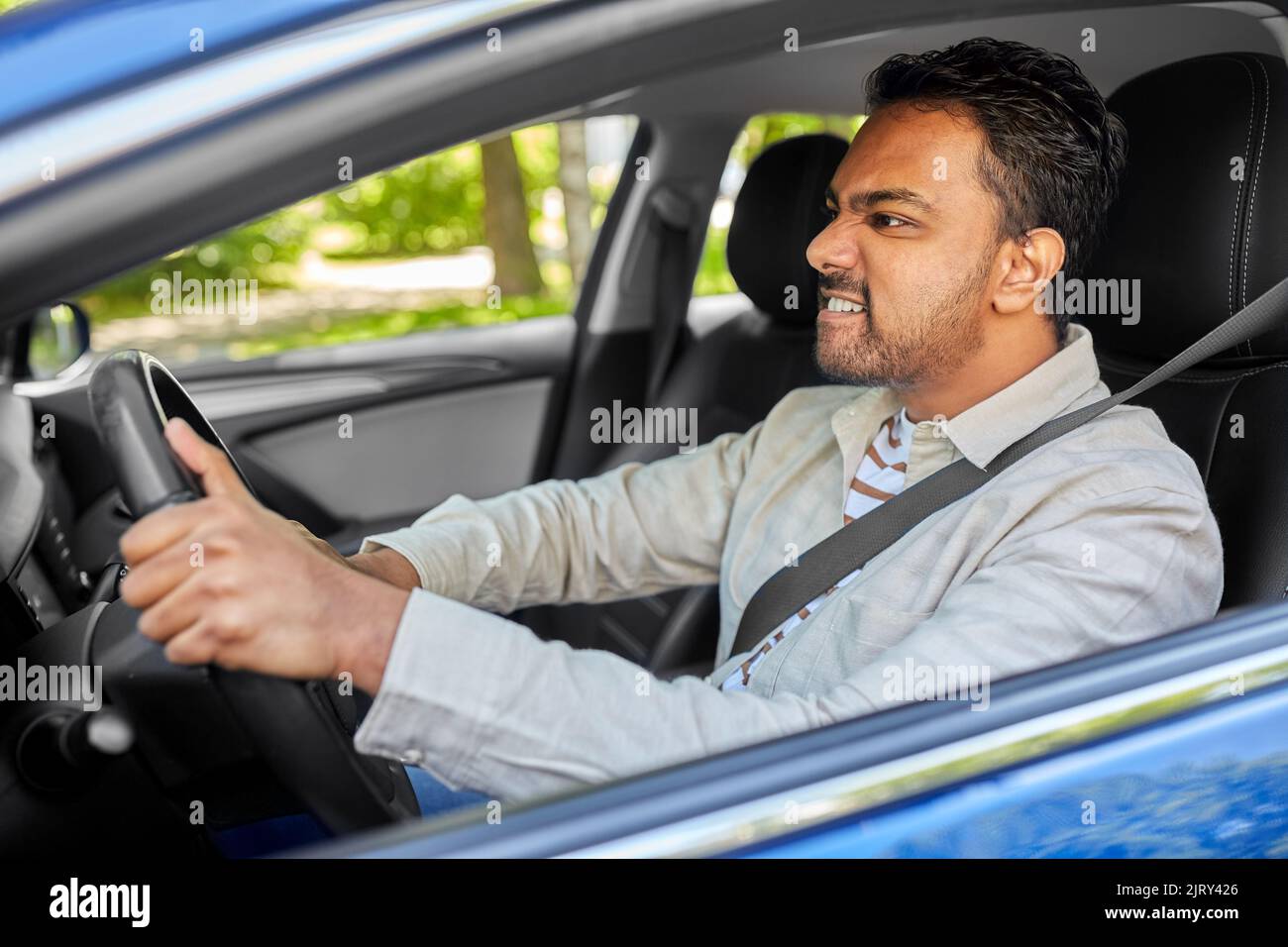 angry indian man or driver driving car Stock Photo - Alamy