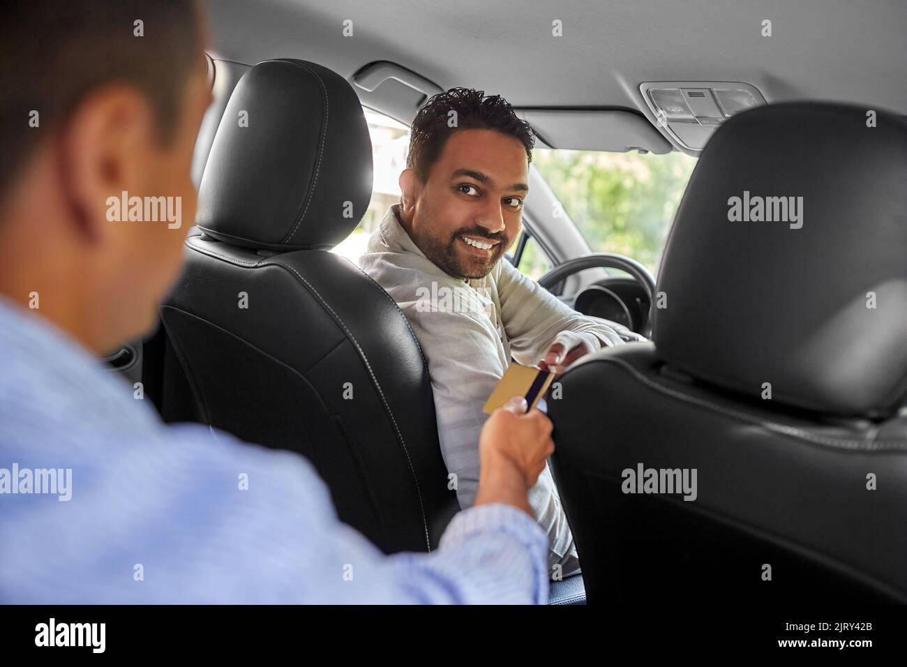taxi car driver taking credit card from passenger Stock Photo - Alamy