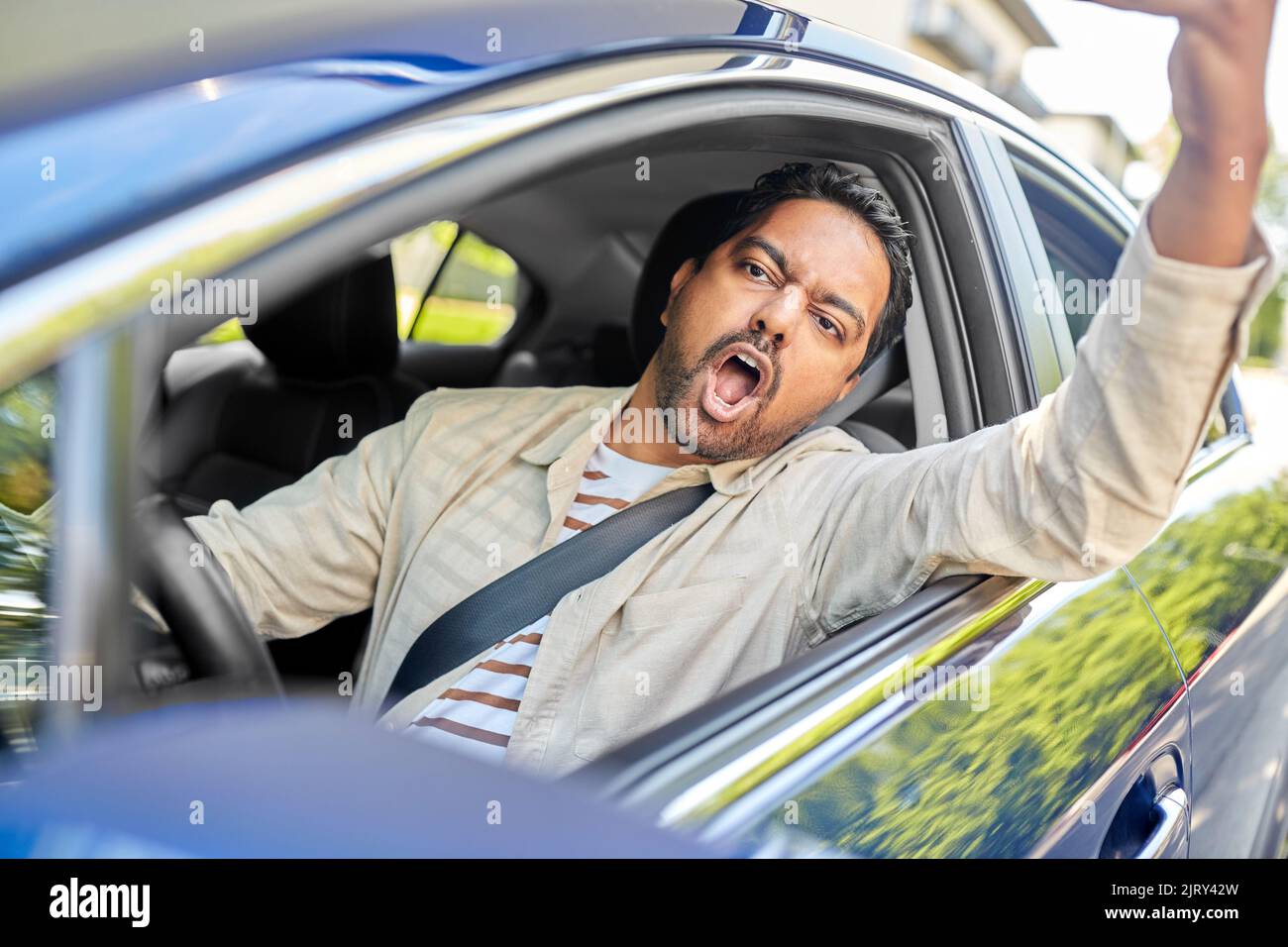 angry indian man or driver driving car Stock Photo - Alamy