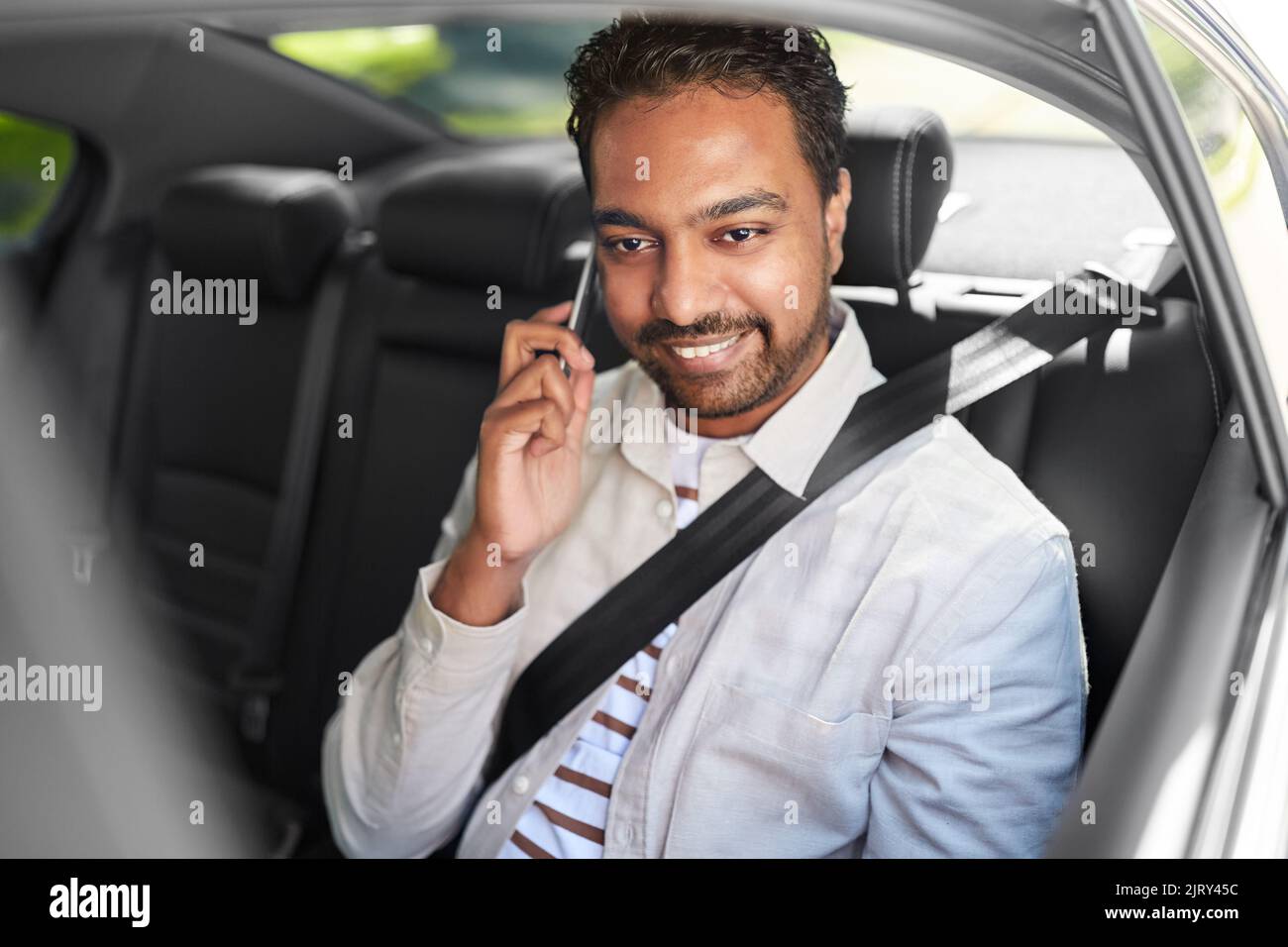 male passenger calling on smartphone in taxi car Stock Photo - Alamy
