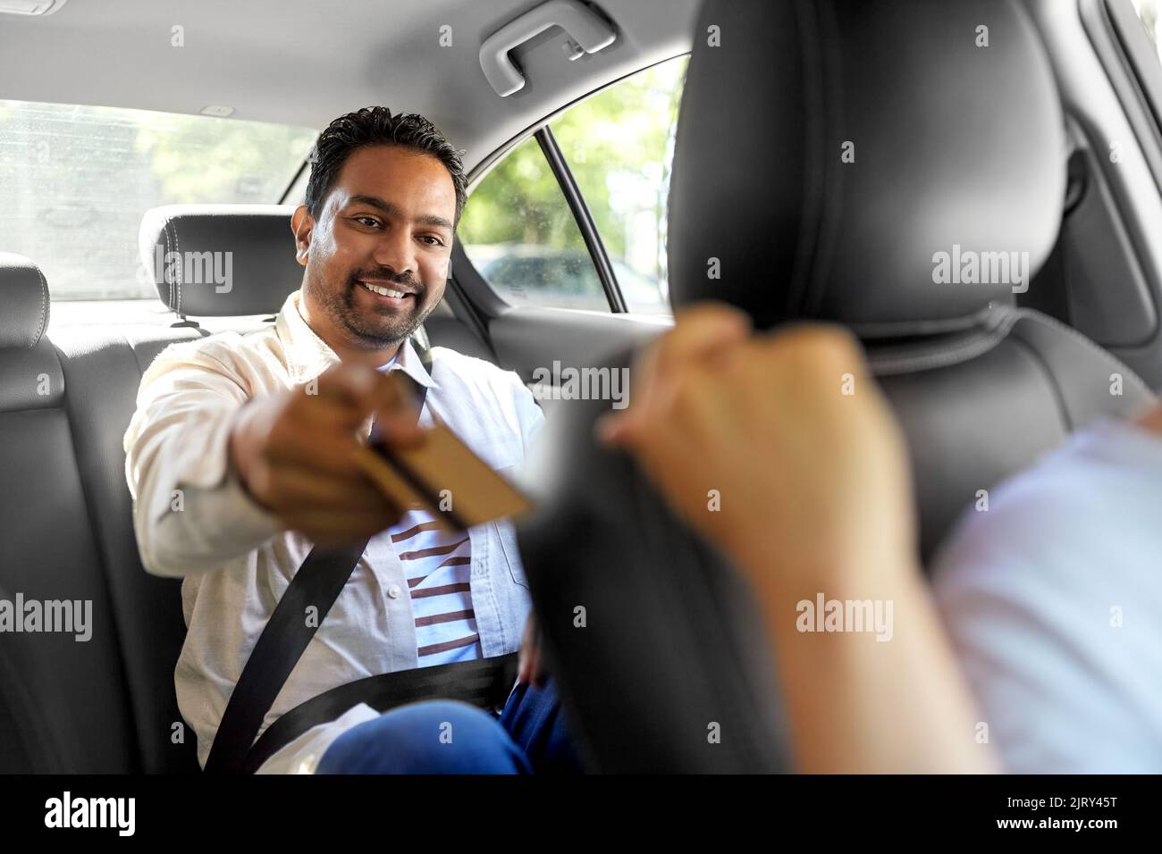 indian man giving credit card to taxi car driver Stock Photo - Alamy