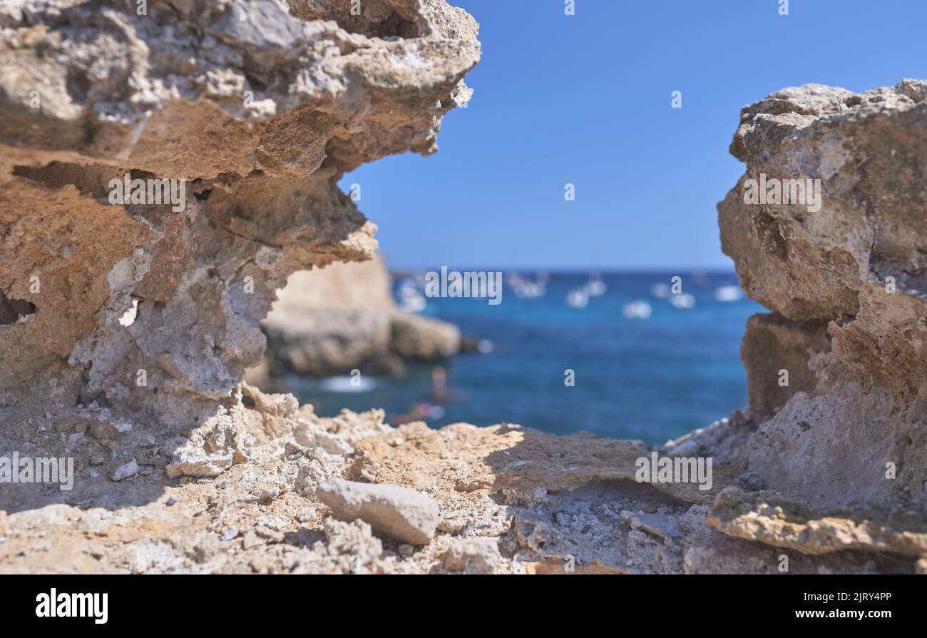 detail of a view of a ship anchoring in the sea through a wall Stock ...
