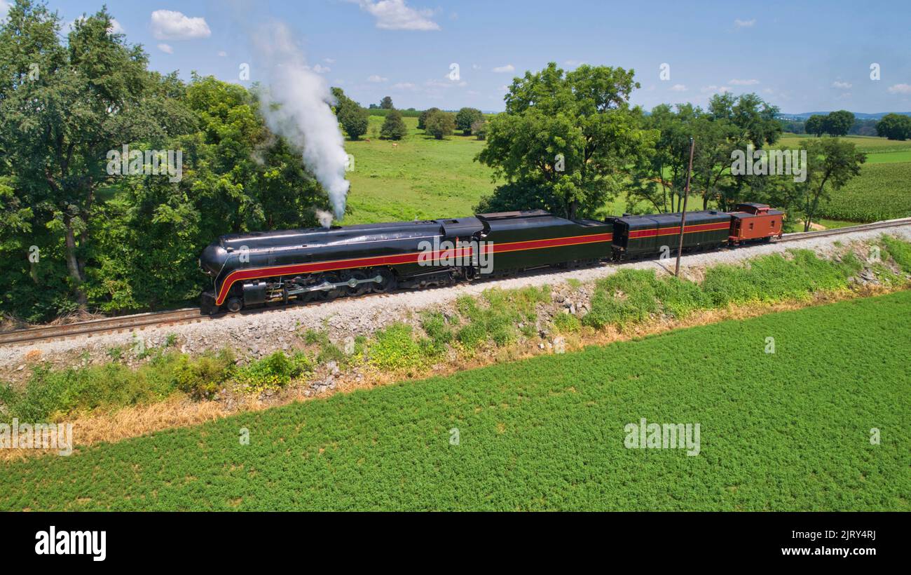 Drone View of an Antique Steam Engine, Blowing Steam and Traveling ...