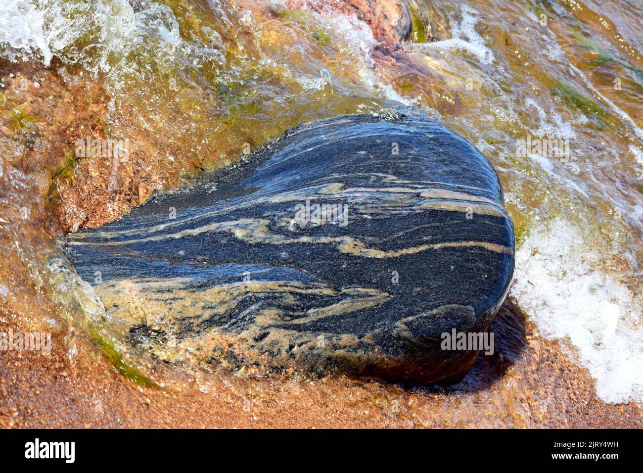 A strange stone made by erosion nature on the beach Stock Photo - Alamy