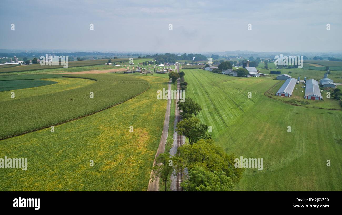 Drone View of Amish Countryside With Barns and Silos and a Single ...