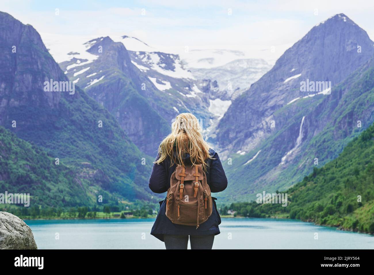 Adventure backpacking woman enjoying view of majestic mountain lake explore travel discover ...