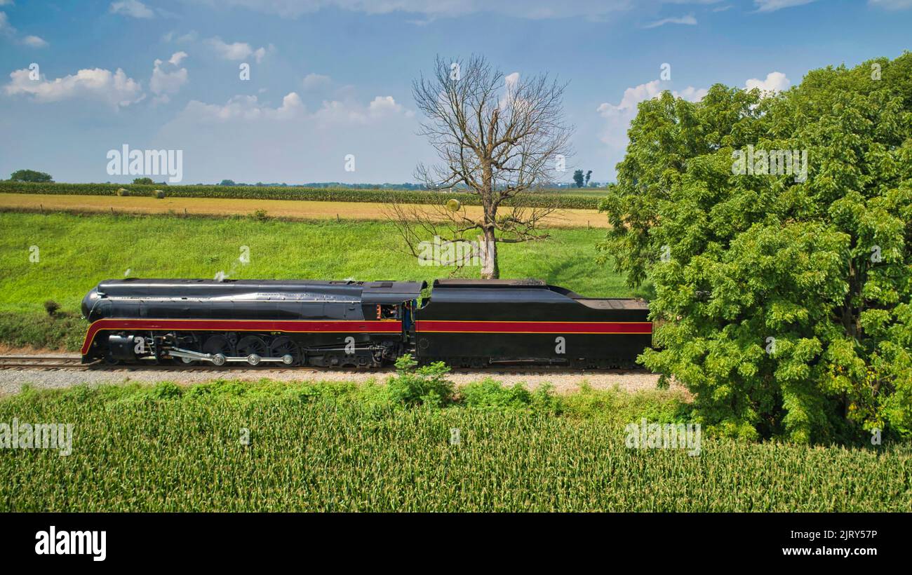 Drone Side View of an Antique Steam Engine, Approaching, Blowing Steam ...