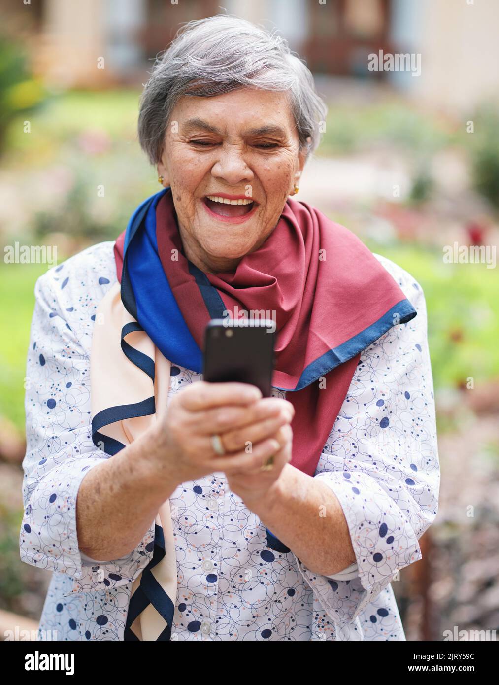 Happy senior woman using smartphone texting browsing messages on mobile ...