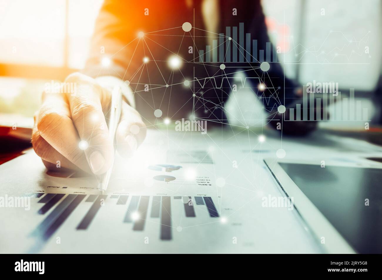 Close up Businessman hand holding pen and pointing at financial ...