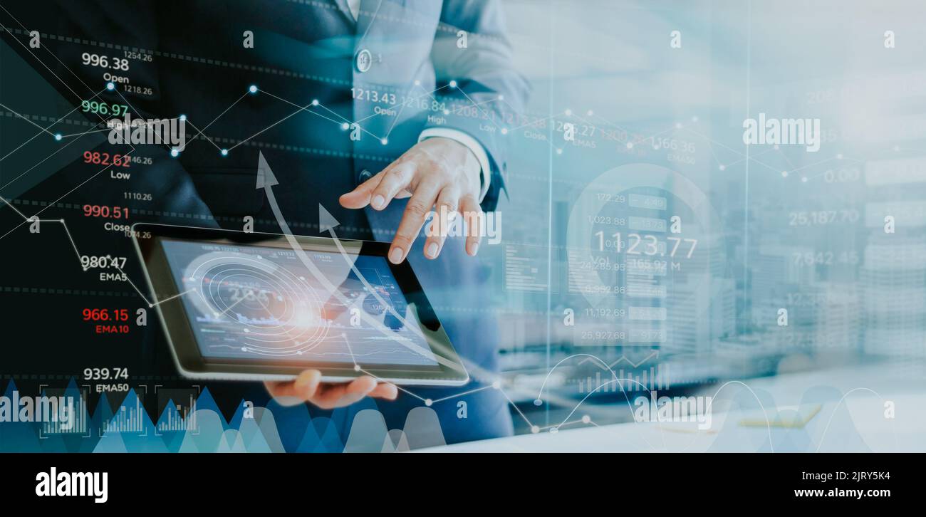 Businessman using tablet analyzing sales data and economic growth graph ...