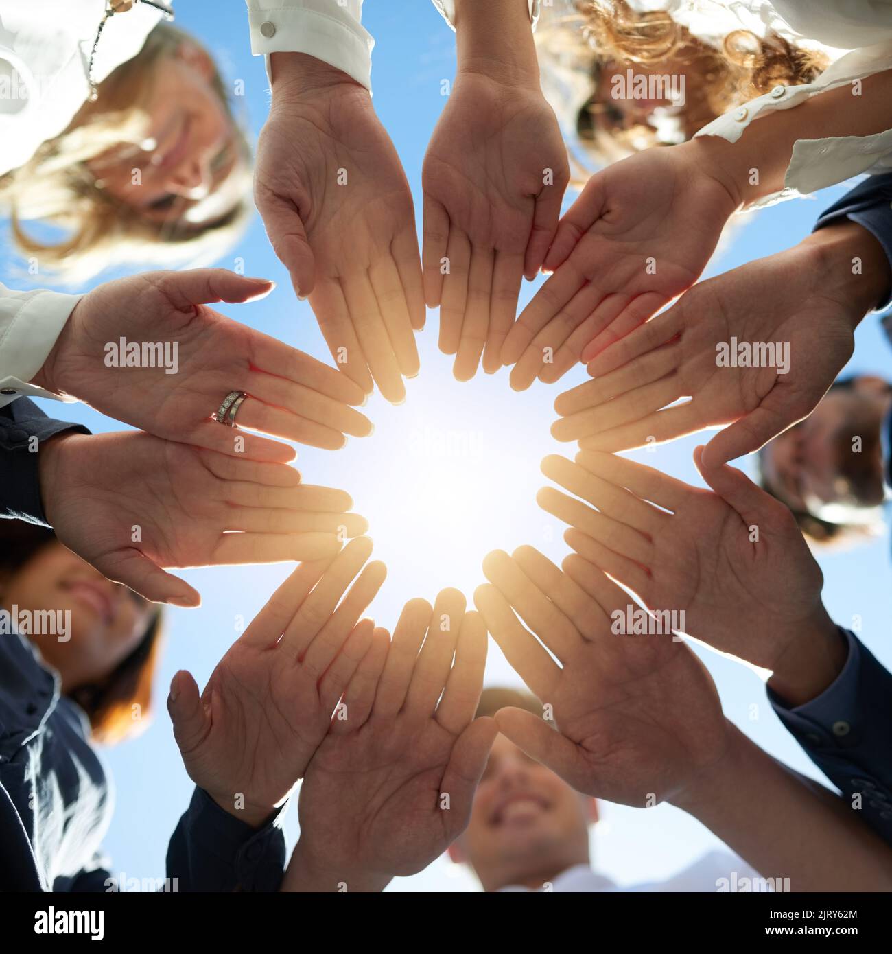 Coming together as one. Low angle shot of a group of businesspeople ...