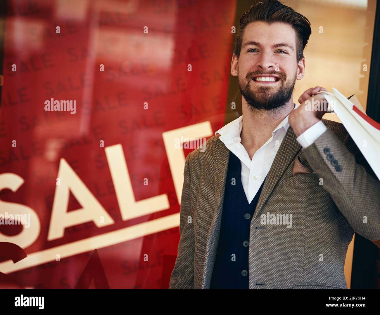 Sale time is the best time to shop. a young man out shopping Stock ...