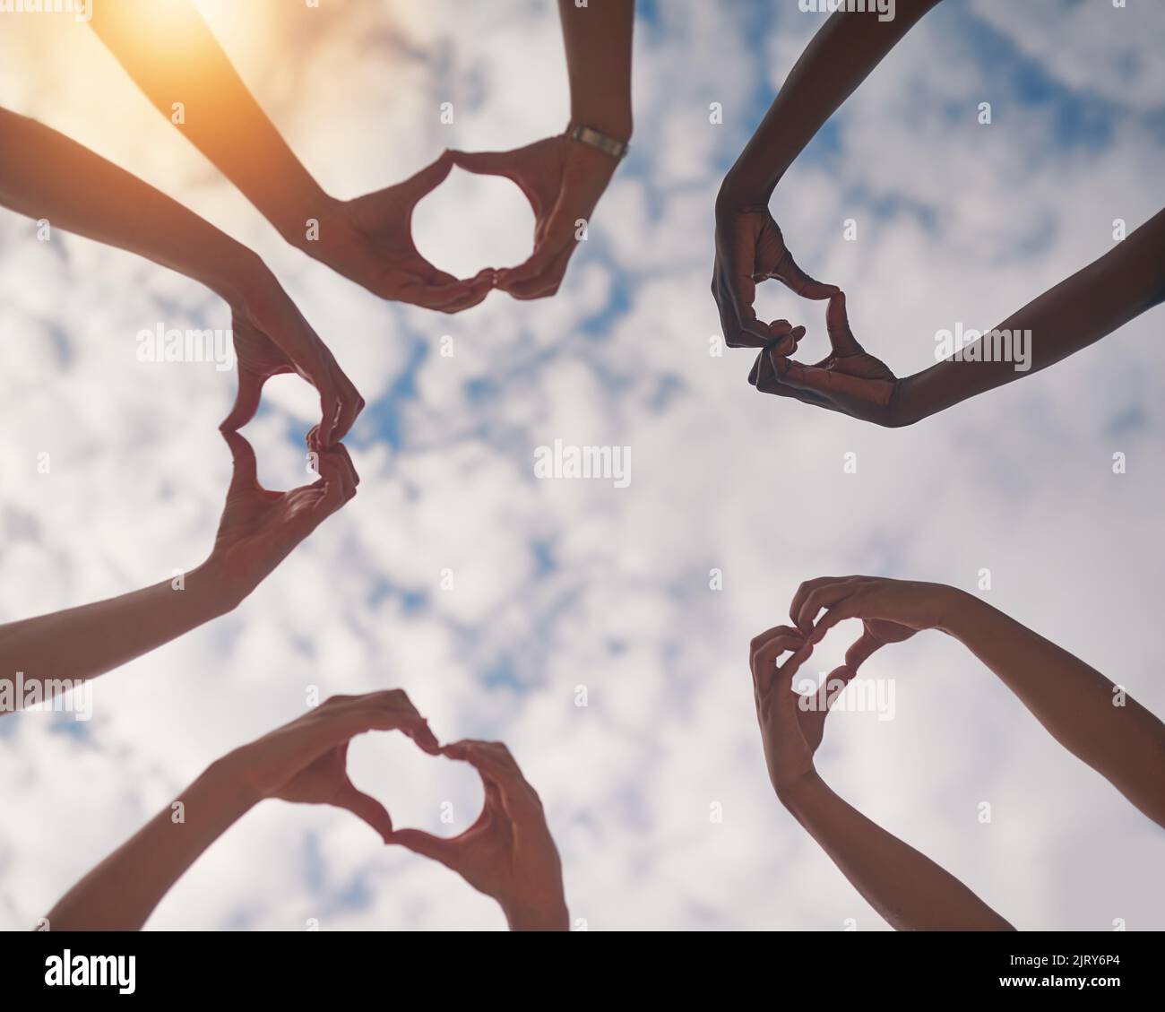 We love long summer days. Low angle shot of a group of unidentifiable ...