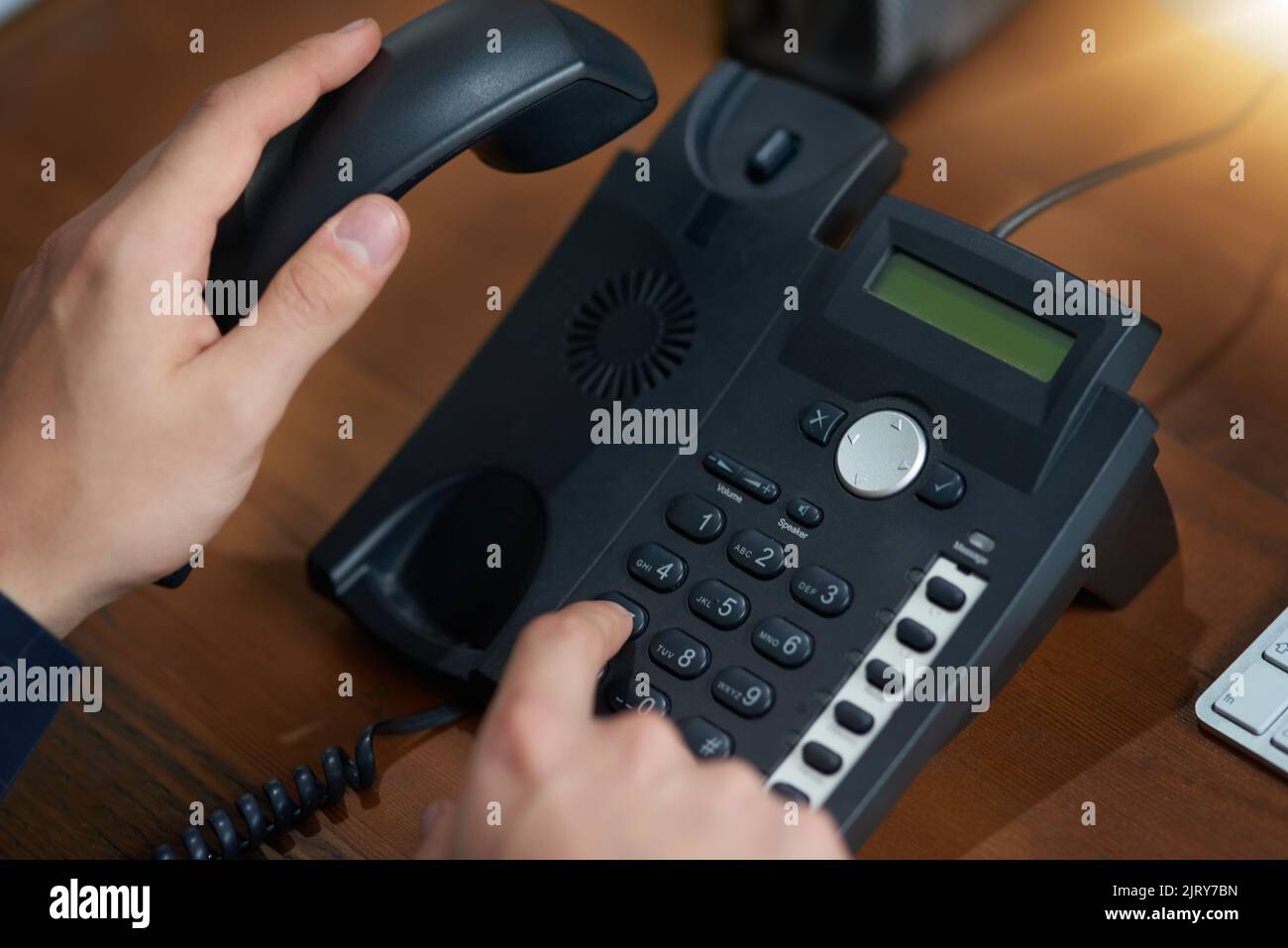Making that important call. an unrecognizable man dialling a number on ...