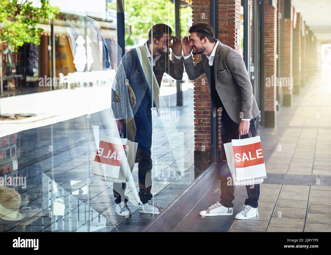 They might have what Im looking for. a man peering through a shops ...