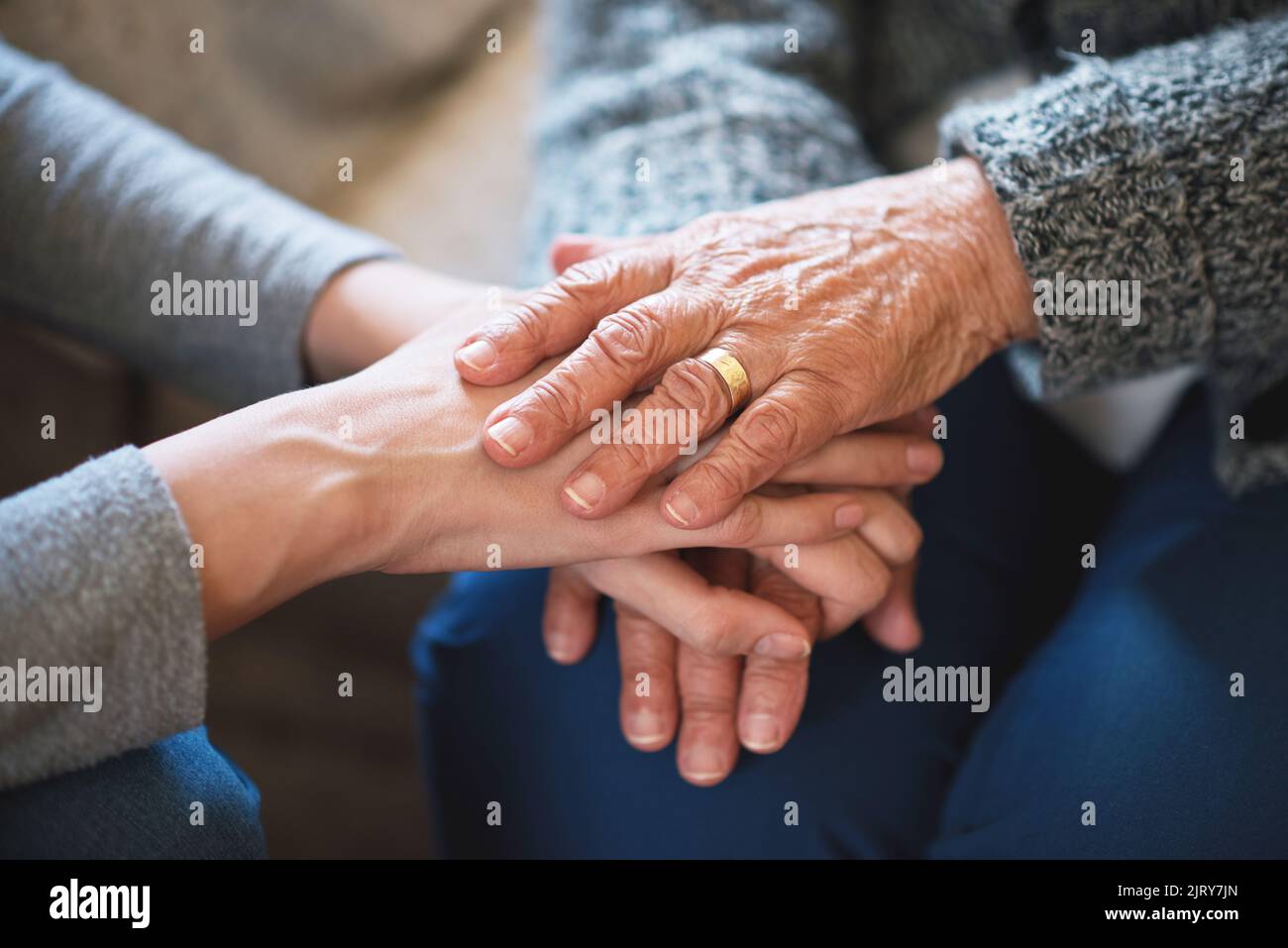 Elderly woman holding hands with daughter Stock Photo - Alamy