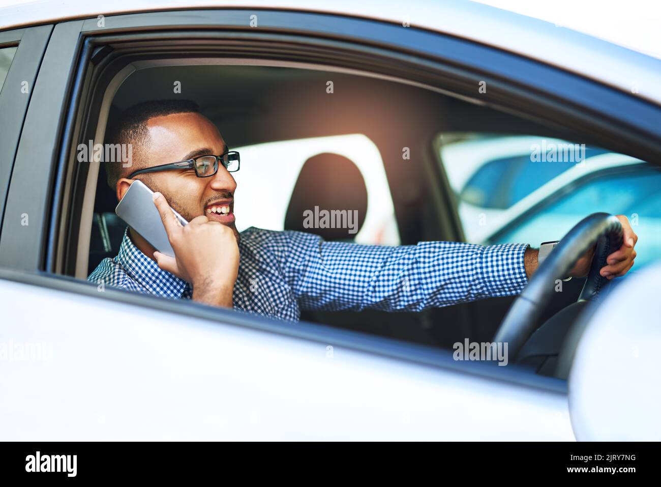 Keeping in contact during his commute. a young businessman talking on a ...