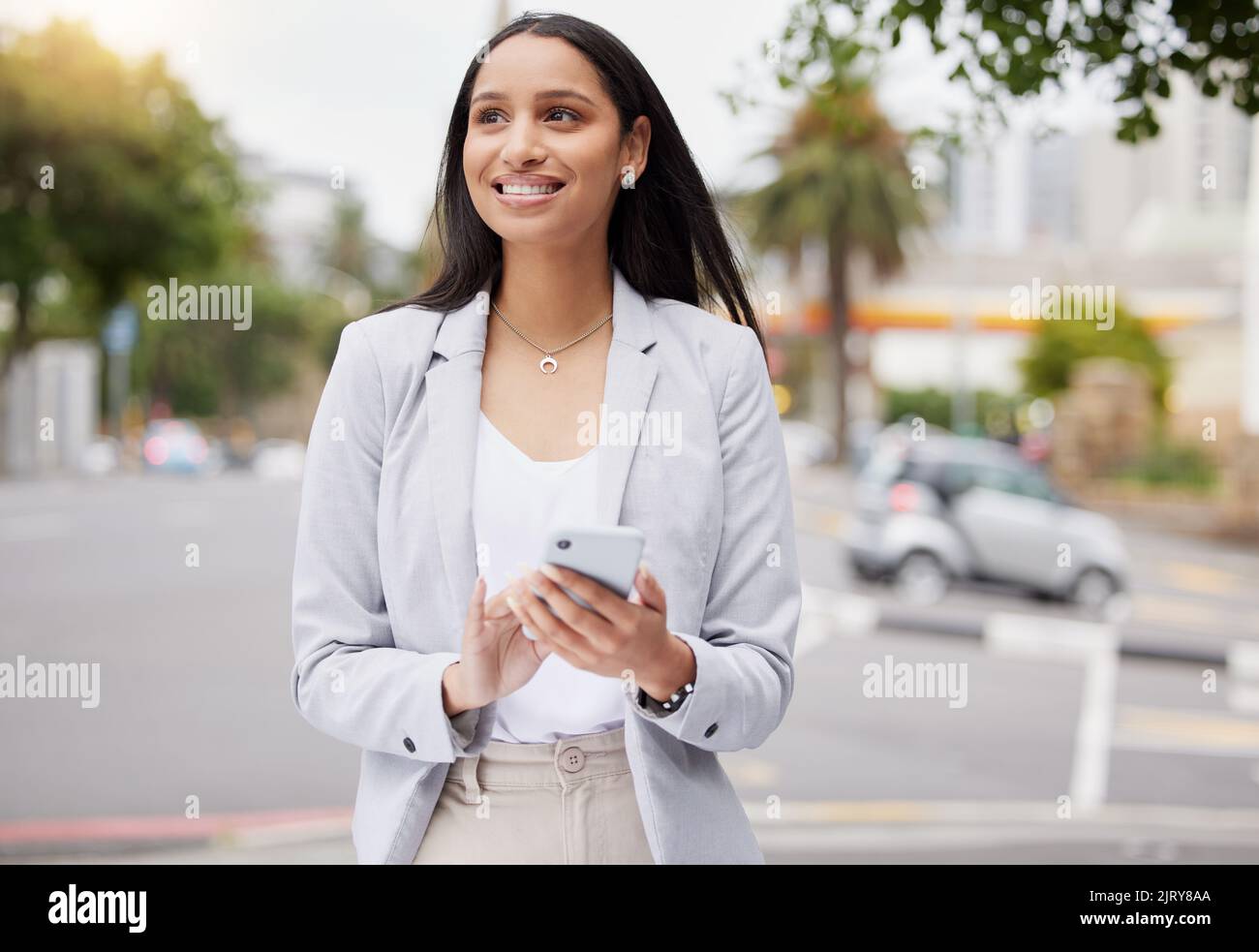 Mobile looking woman walking typing hi-res stock photography and images ...