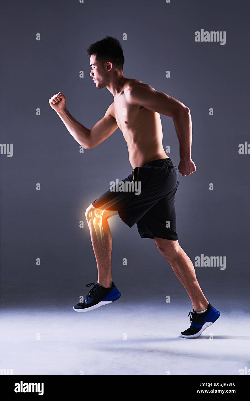 Running through the pain. Full length shot of a young man in the studio ...
