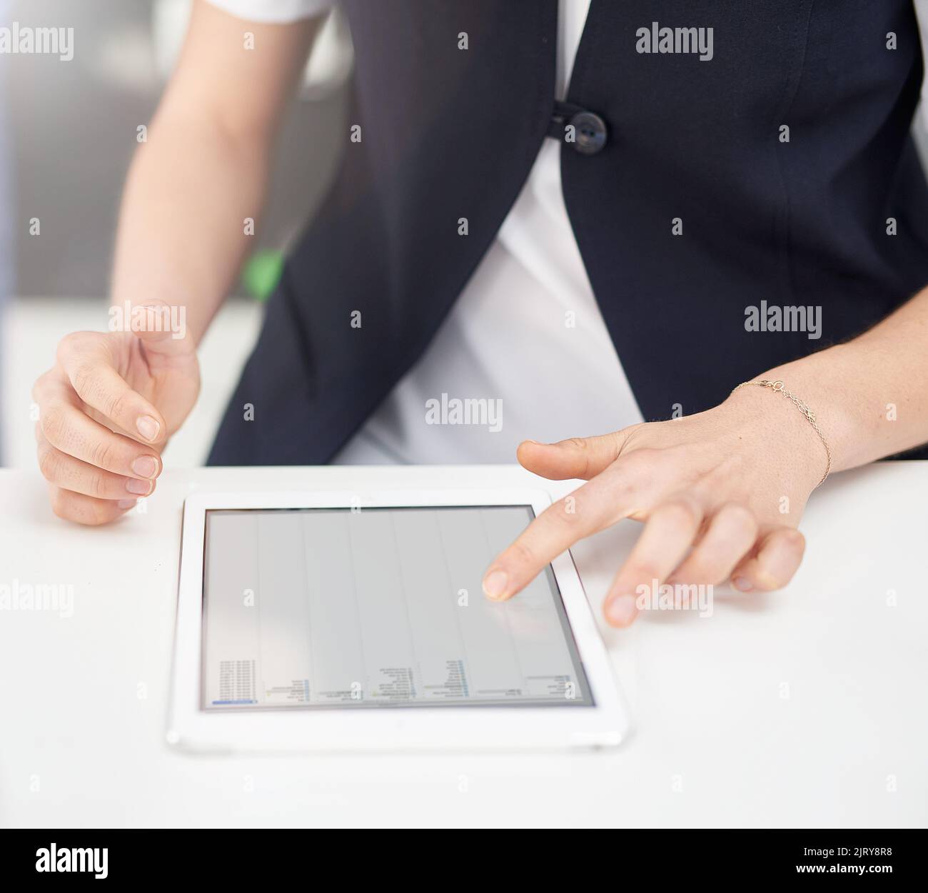 Keeping track of her patients progress. an unidentifiable nurse using a ...