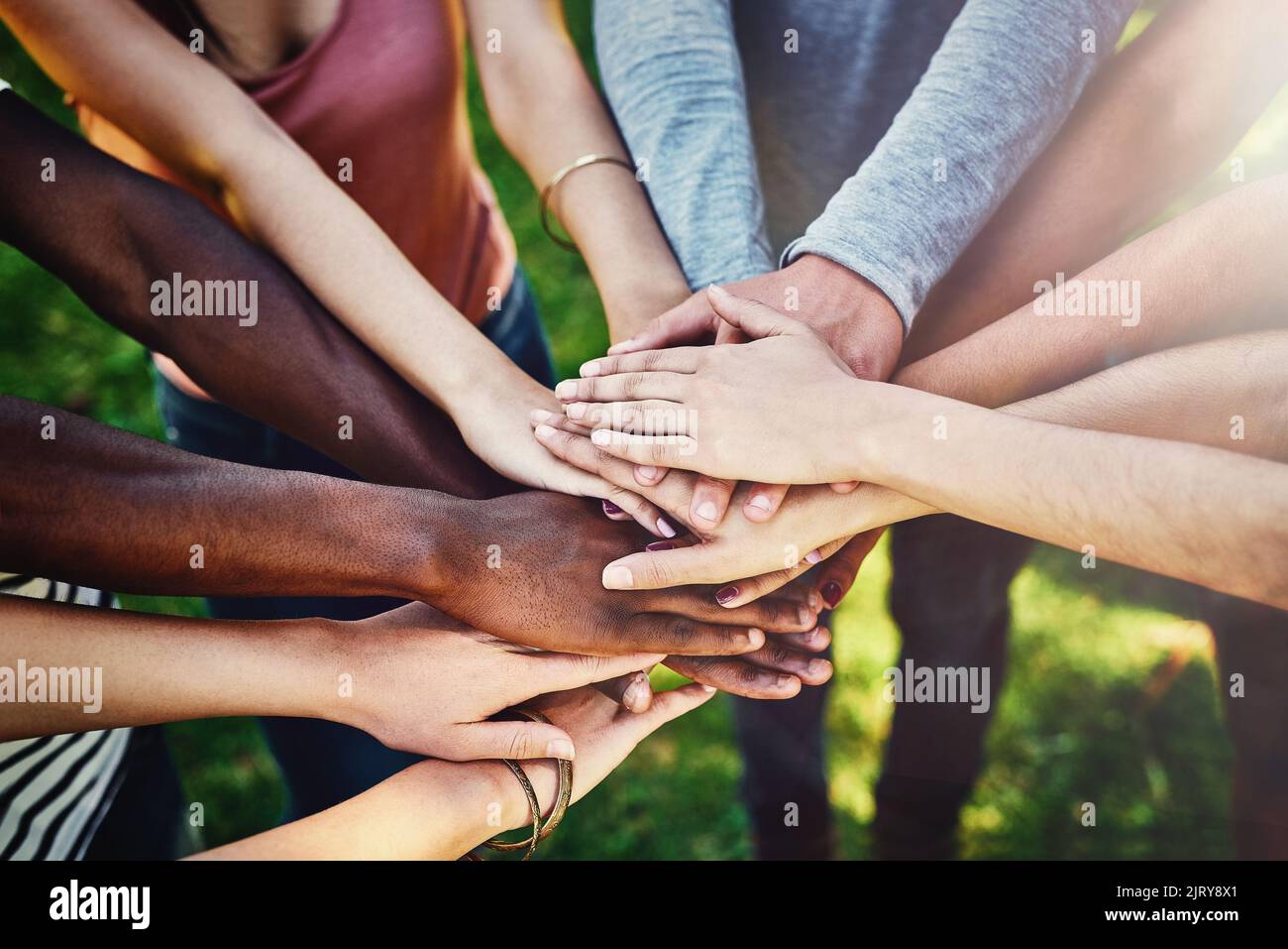 Banding together as one. a group of friends joining their hands in ...