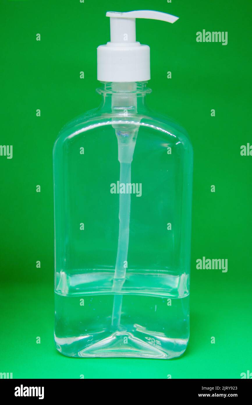 transparent jar of gel alcohol with white lid on a green background in ...